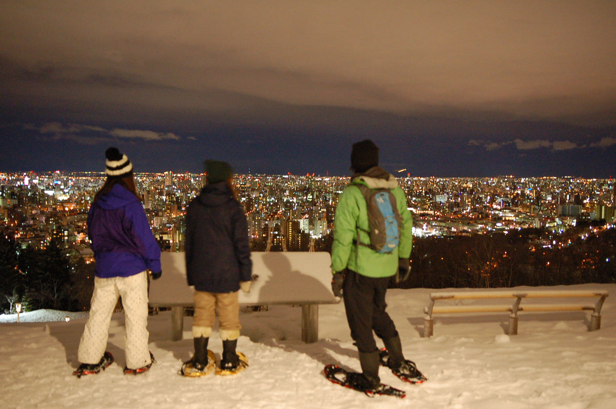 Snowshoe trekking in night snow forest with hot wine / Sapporo ...